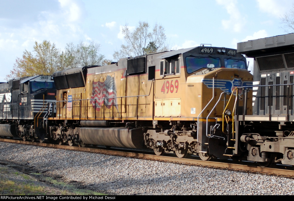 UP SD-70M #4969 is mid consist on an eastbound about to cross Alden Rd
